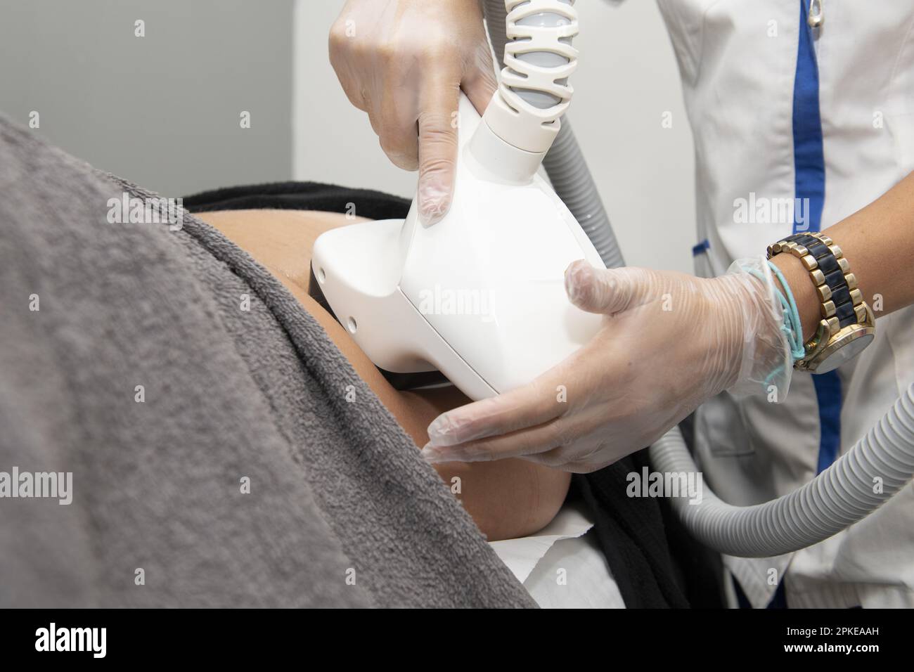 A masseuse with plastic gloves applying treatments with aesthetic ...