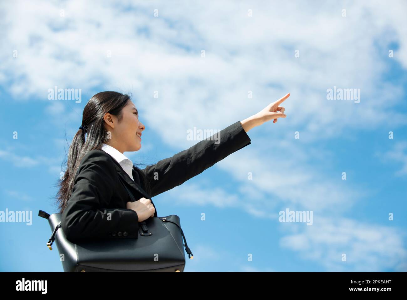 Woman pointing at sky hi-res stock photography and images - Alamy