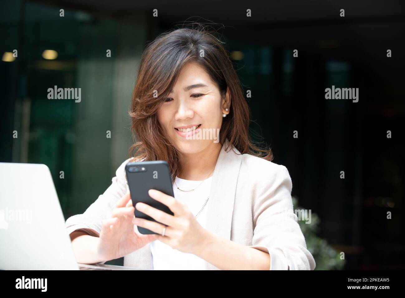 Woman operating smartphone outside hi-res stock photography and images ...
