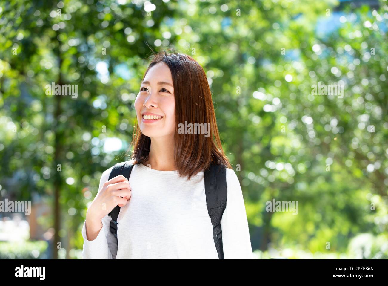 Female student smiling with green background Stock Photo - Alamy