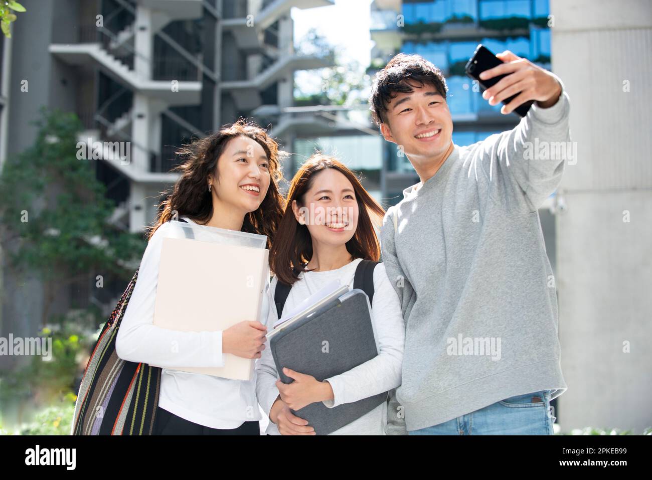 Three students taking selfies with smiles on their faces Stock Photo ...