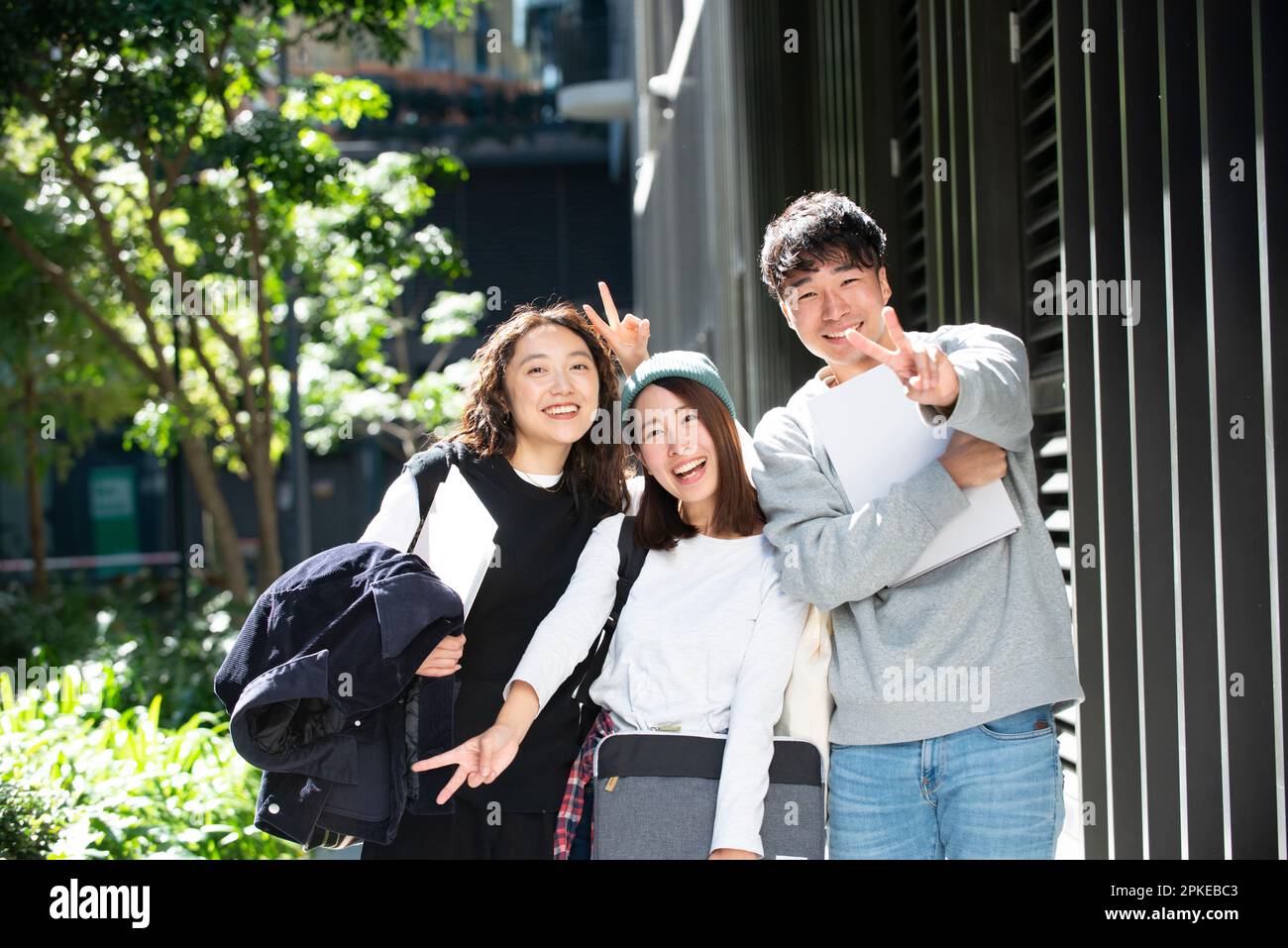 Three students posing with smiles Stock Photo - Alamy