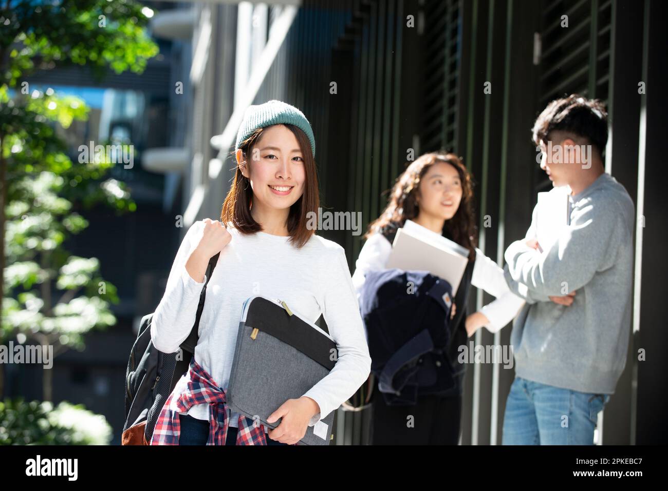 Female student holding computer pouch and smiling Stock Photo - Alamy