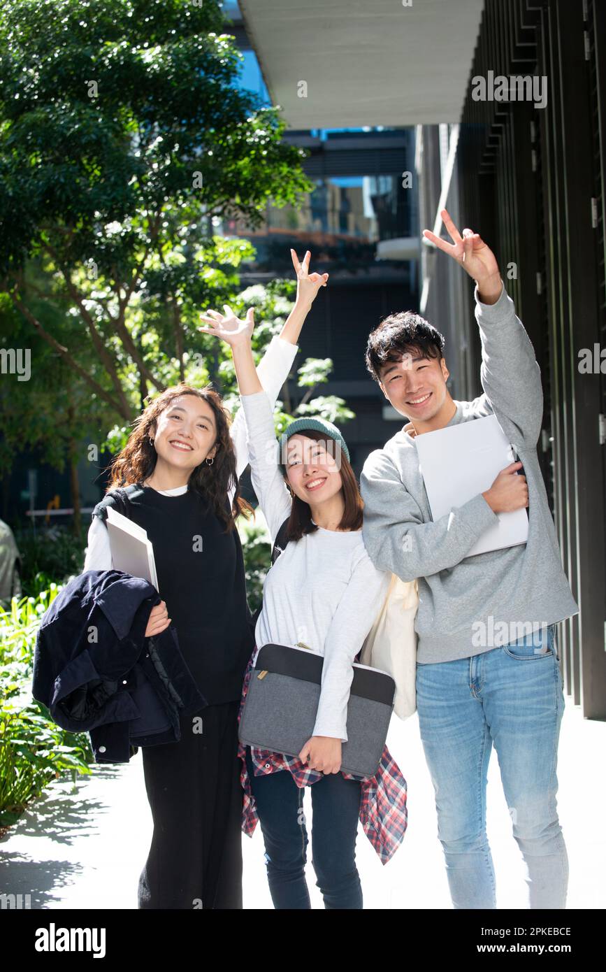 Three students posing with a smile Stock Photo - Alamy