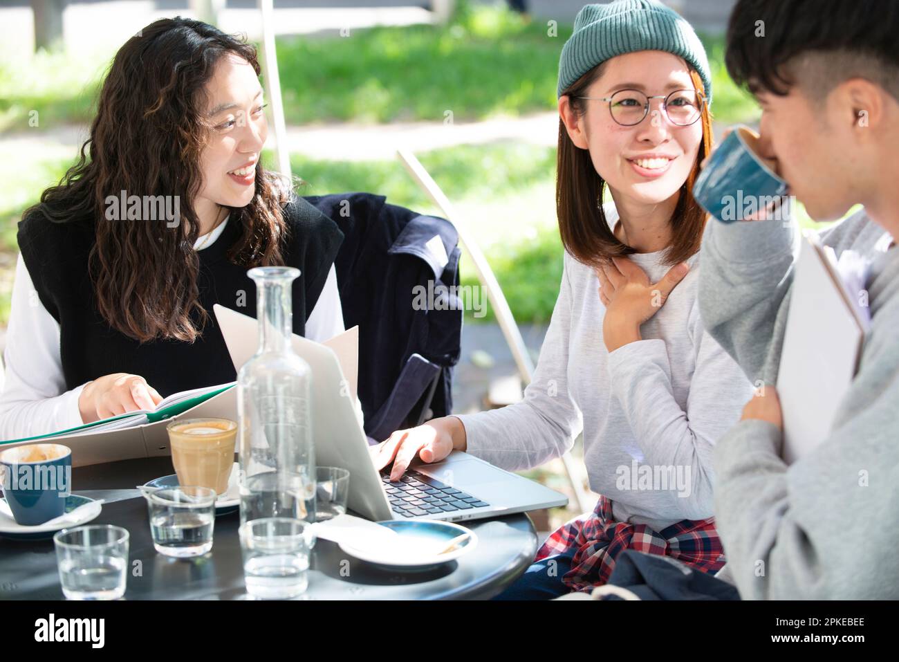 Three students studying at a café Stock Photo - Alamy