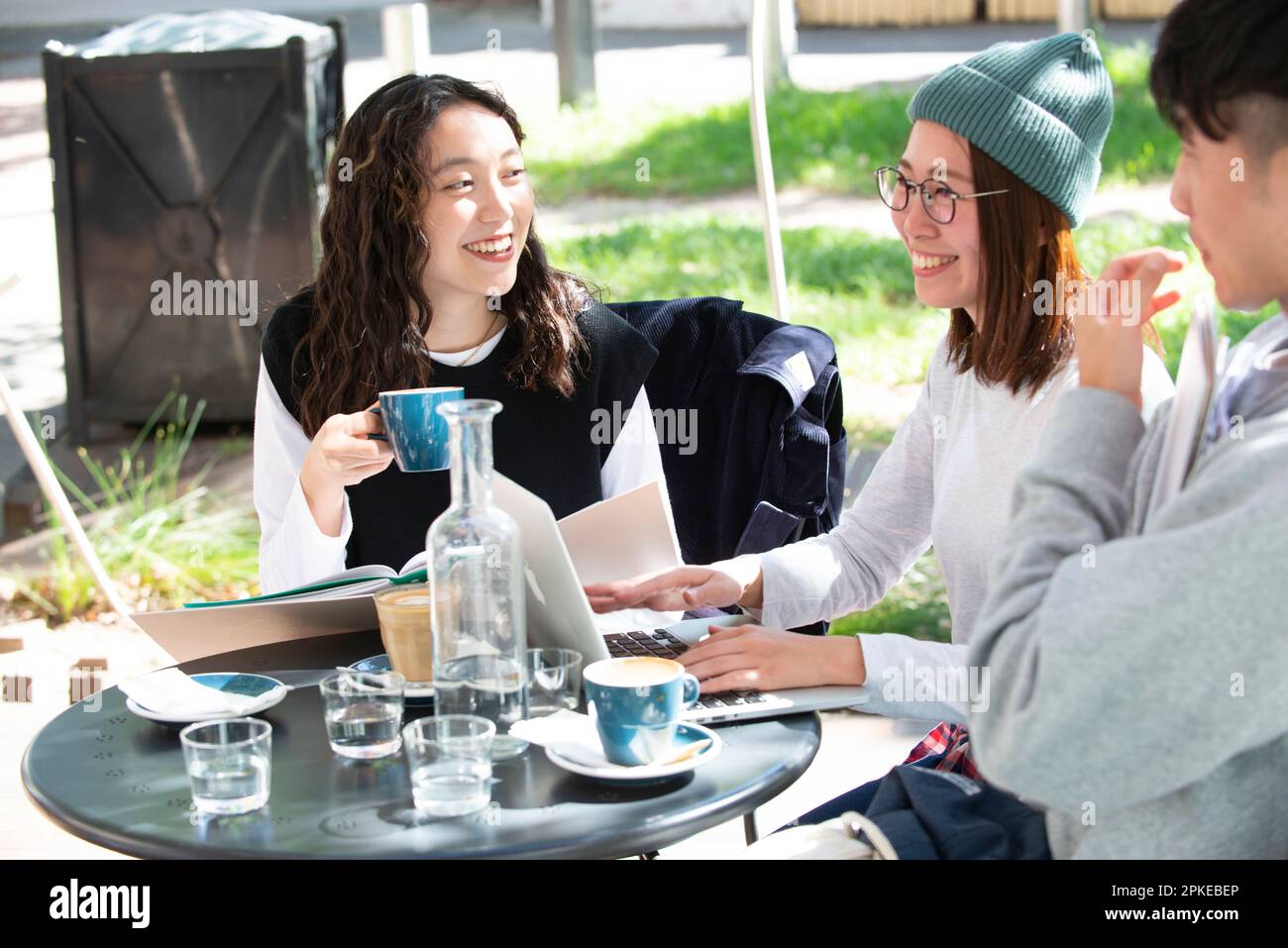 Three students studying at a café Stock Photo - Alamy