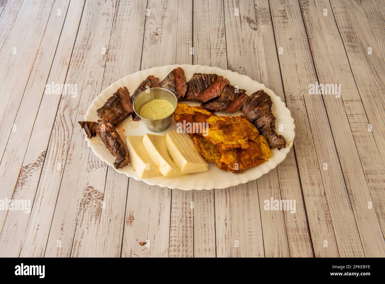Tray of Latin American-style barbecue with fresh cheese and fried ...