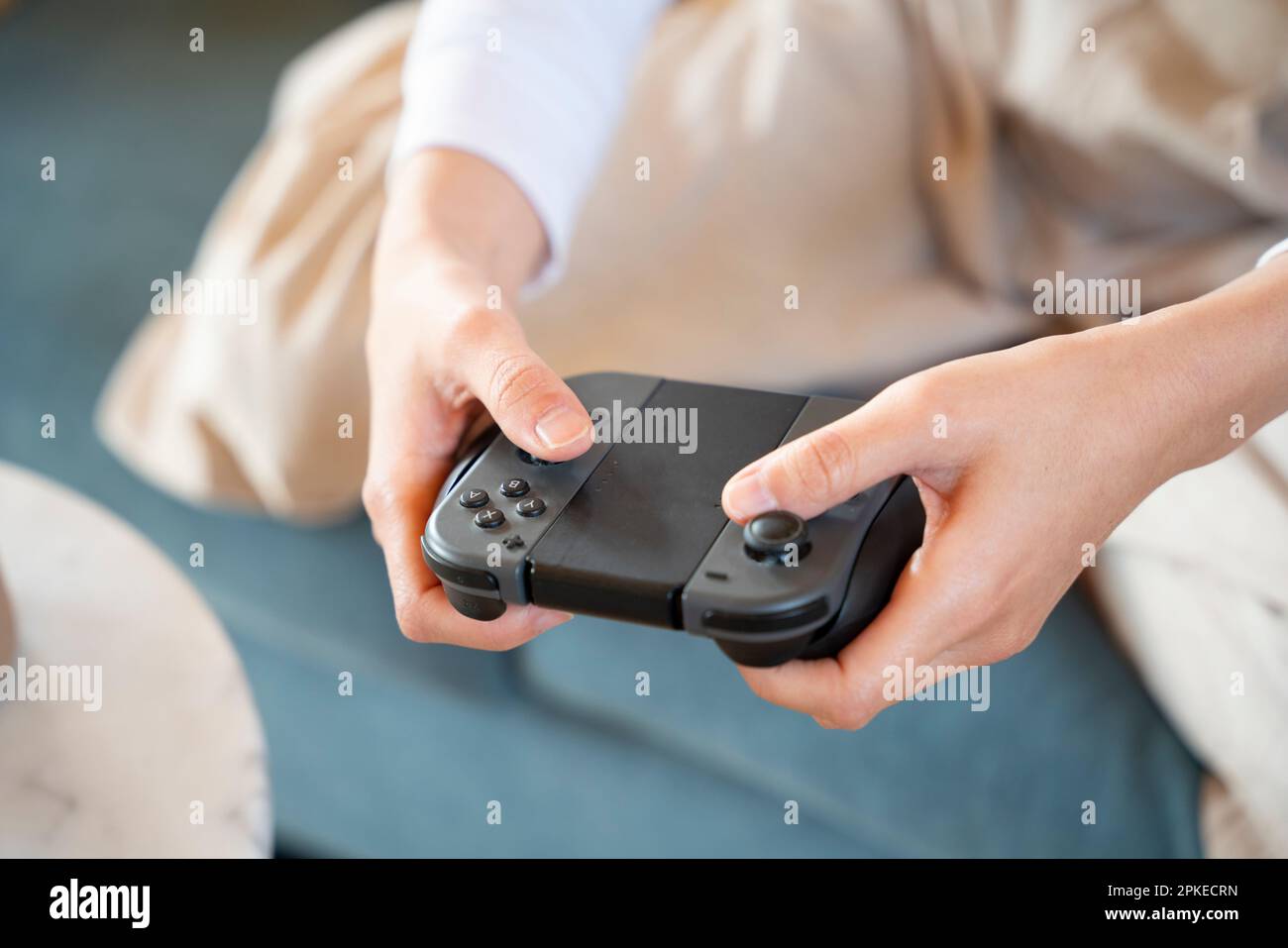 Woman holding a game controller Stock Photo - Alamy