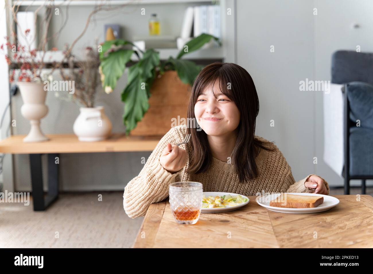 Woman eating breakfast alone Stock Photo - Alamy