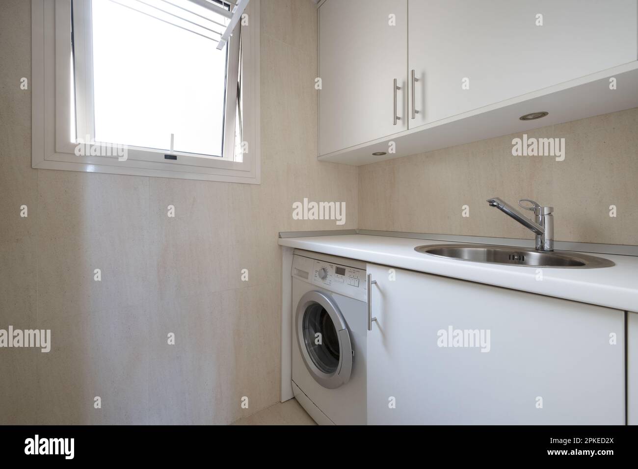 small kitchen equipped with integrated appliances and stainless steel ...