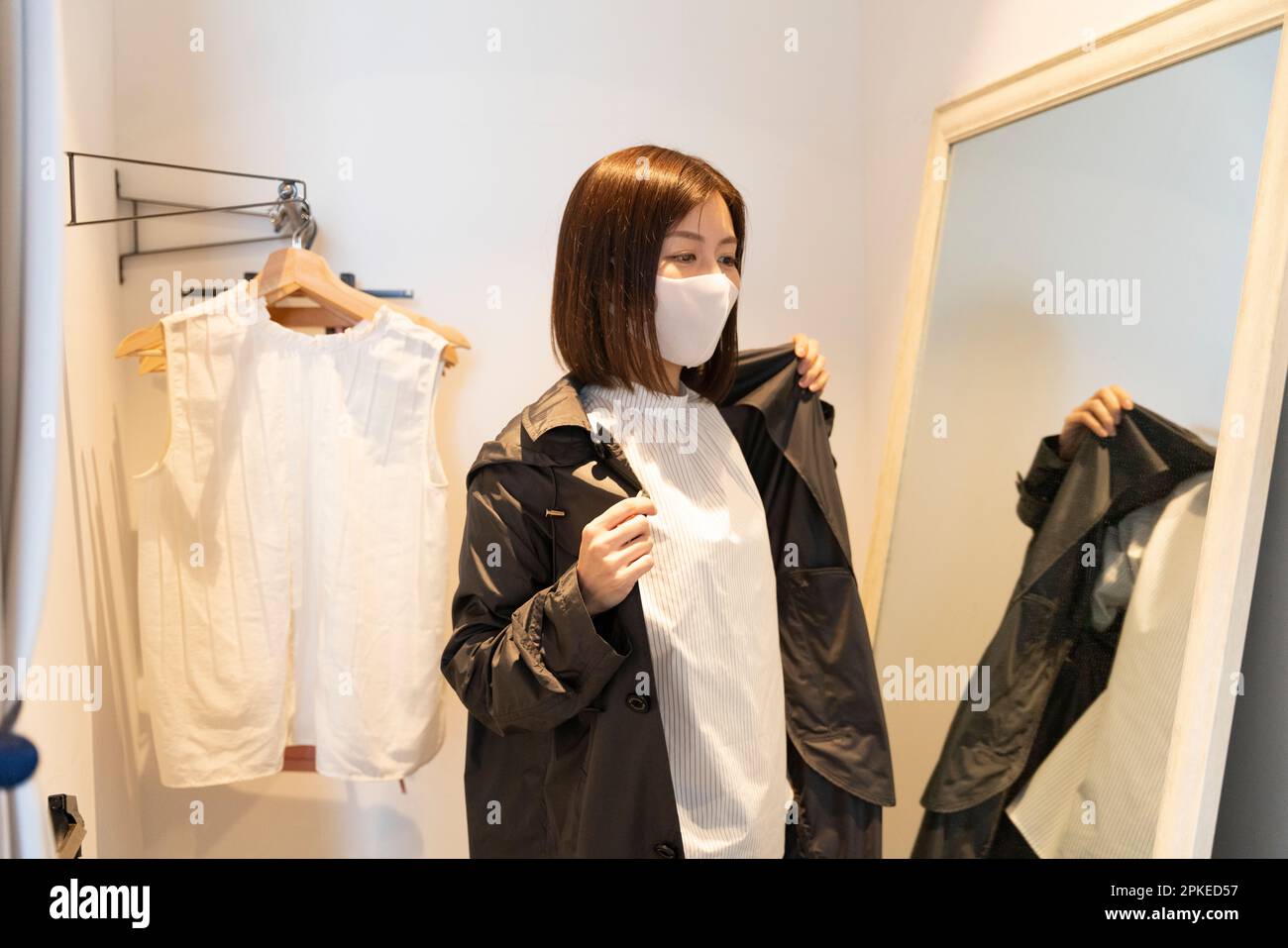 Woman changing clothes in fitting room Stock Photo - Alamy Woman changing clothes in fitting room Stock Photo - Alamy