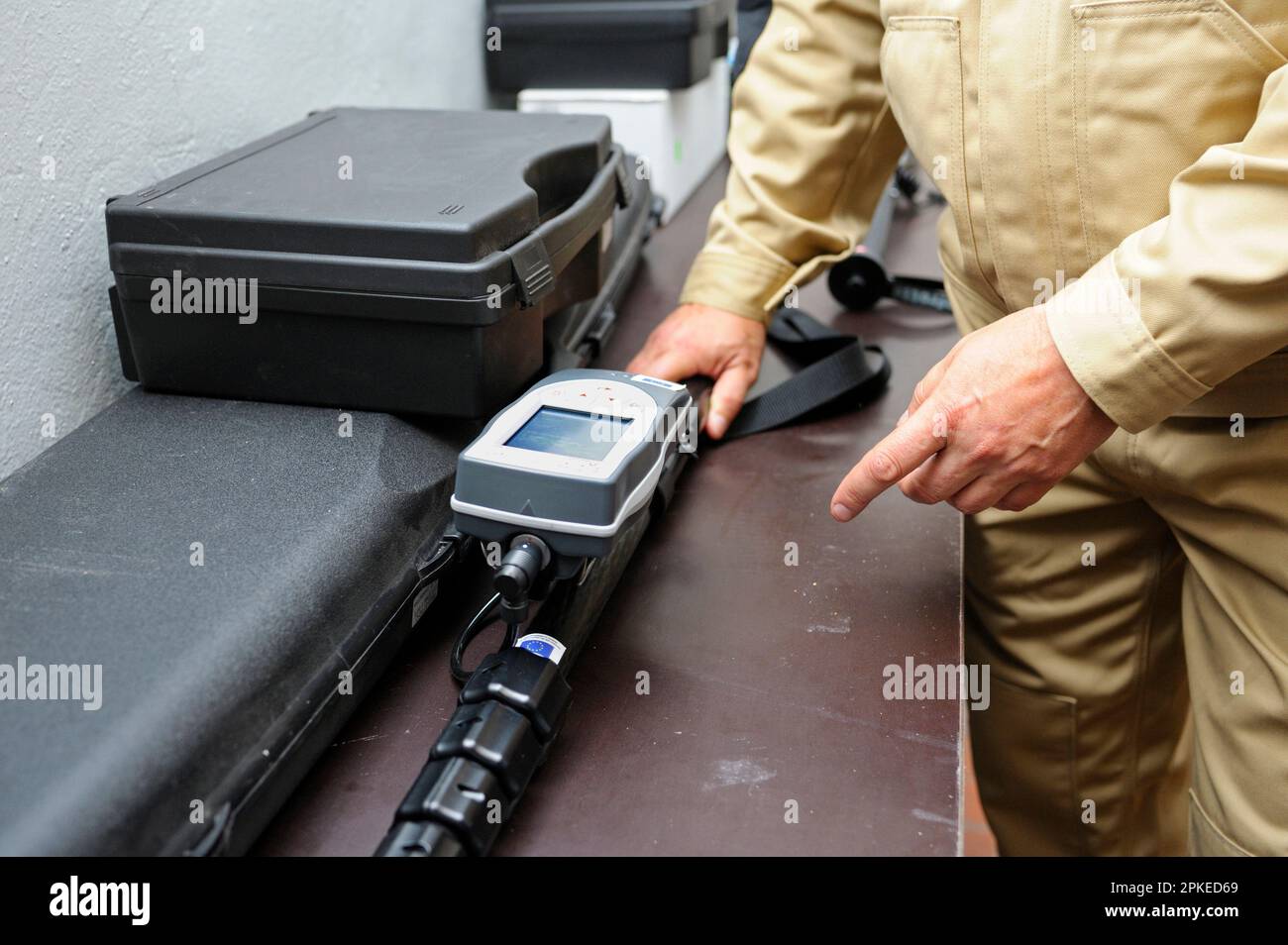 Radiation detector testing. Dosimetrist hands adjusting a portable ...