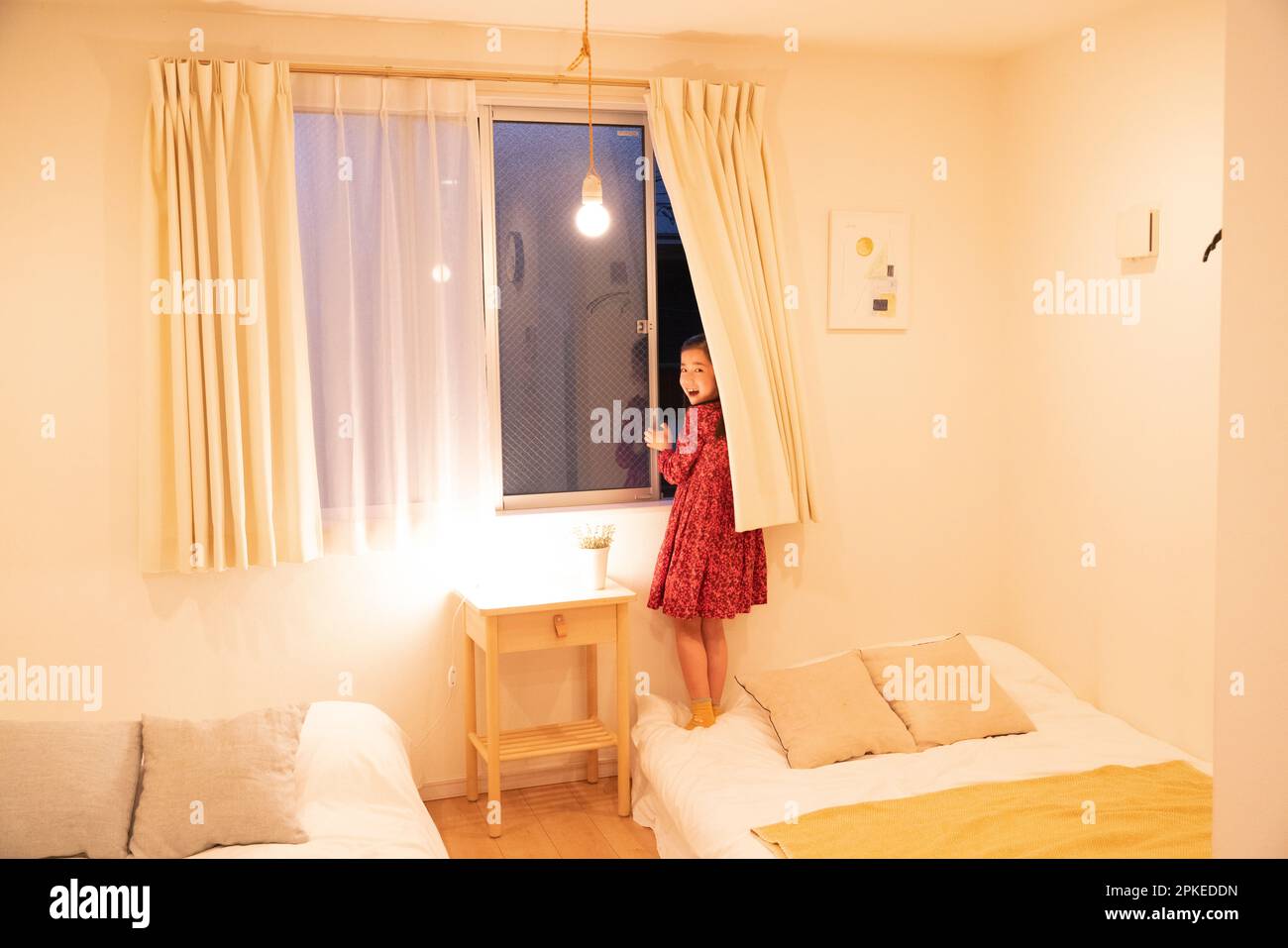 Girl looking back near the window Stock Photo - Alamy