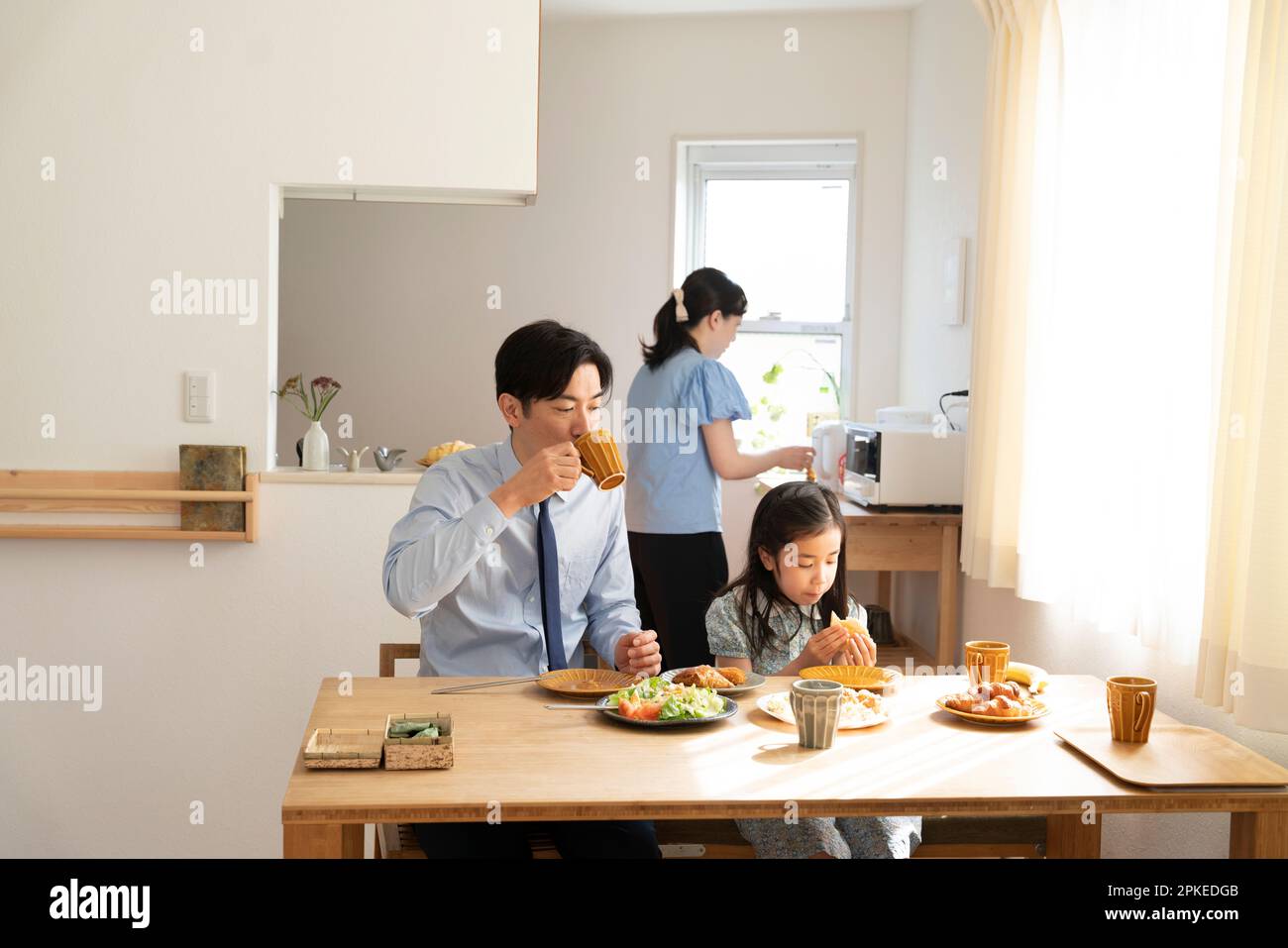 Breakfast scene of a family of three Stock Photo - Alamy
