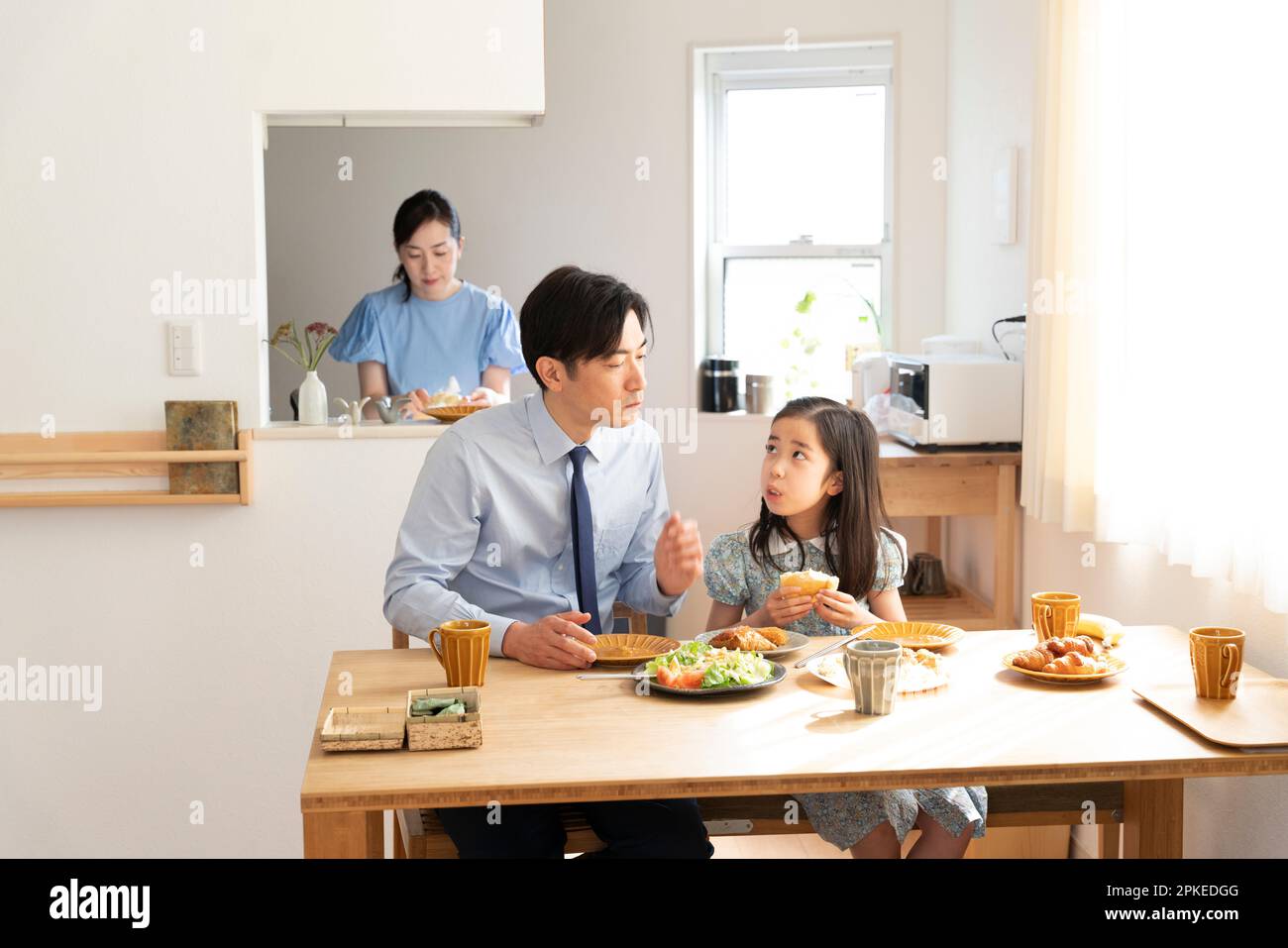 Breakfast scene of a family of three Stock Photo - Alamy