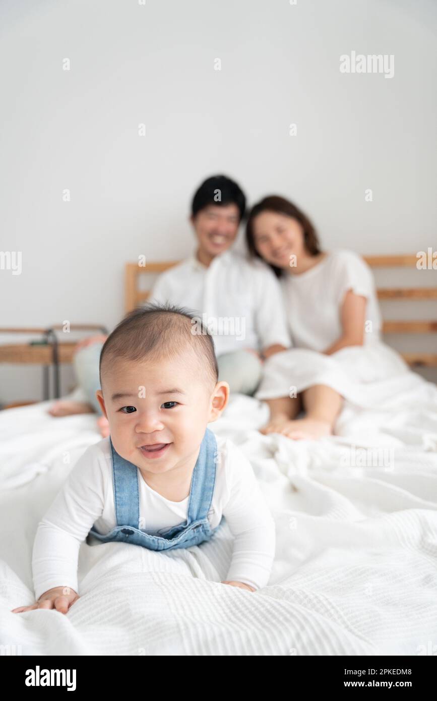 Laughing baby crawling in bed Stock Photo - Alamy