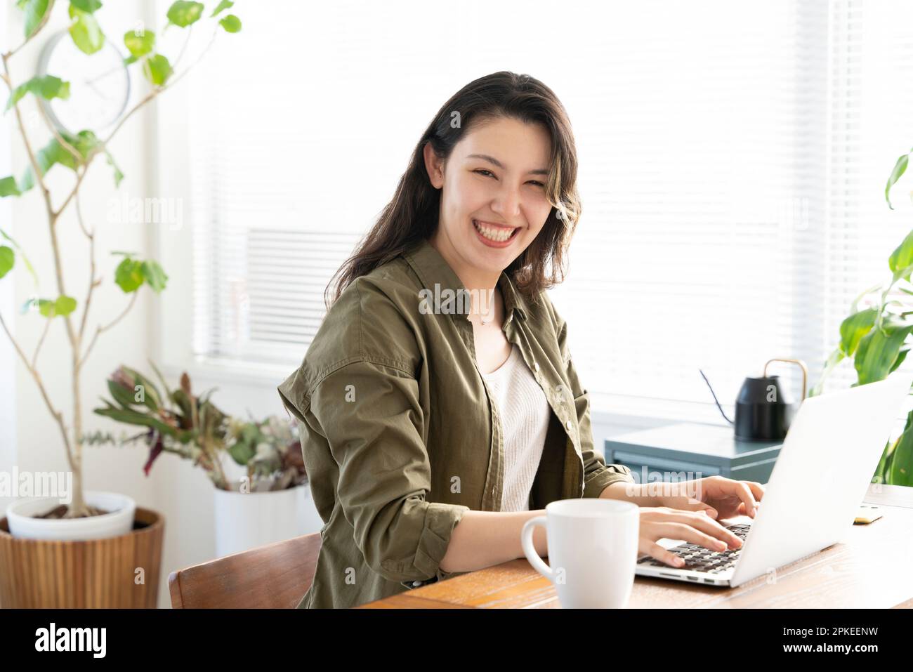 Woman laughing while touching computer Stock Photo - Alamy