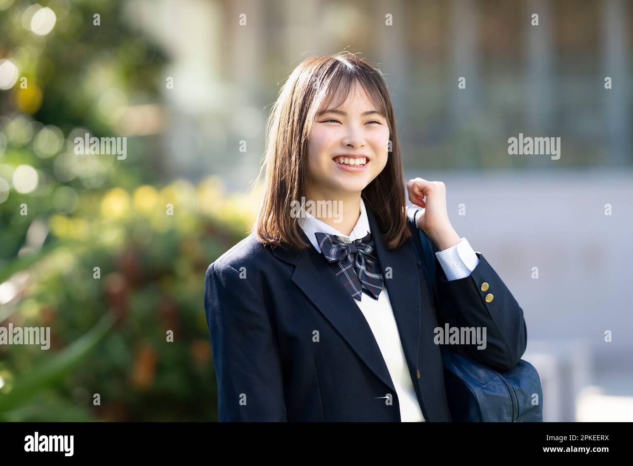 A high school girl in school uniform smiling Stock Photo - Alamy
