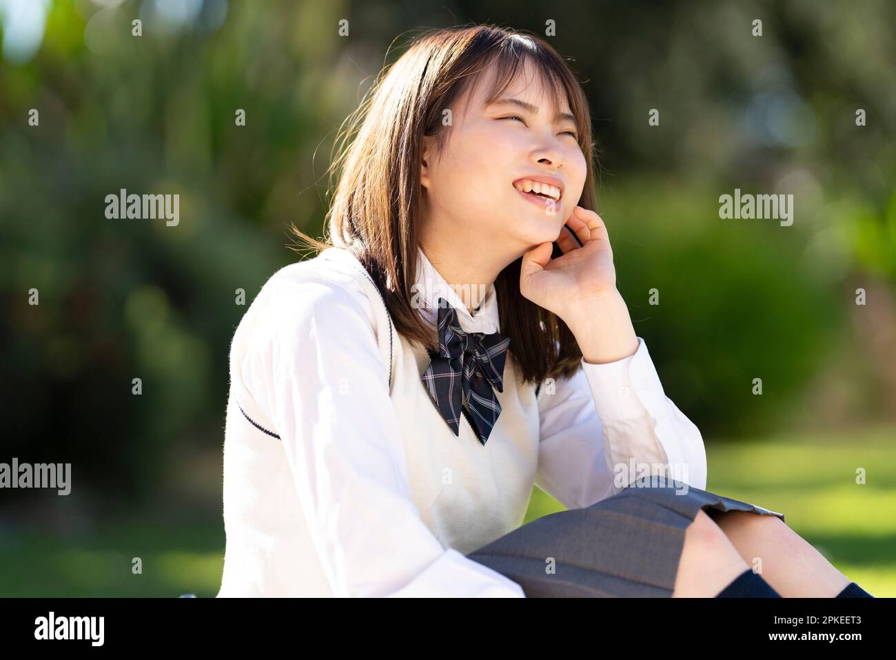 Female student in school uniform sitting and smiling Stock Photo - Alamy