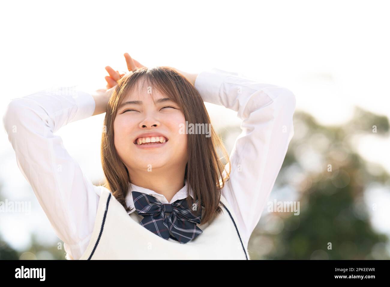 Female student in school uniform laughing in school uniform Stock Photo ...