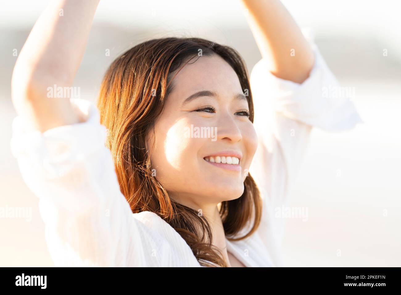 Woman laughing while stretching Stock Photo - Alamy
