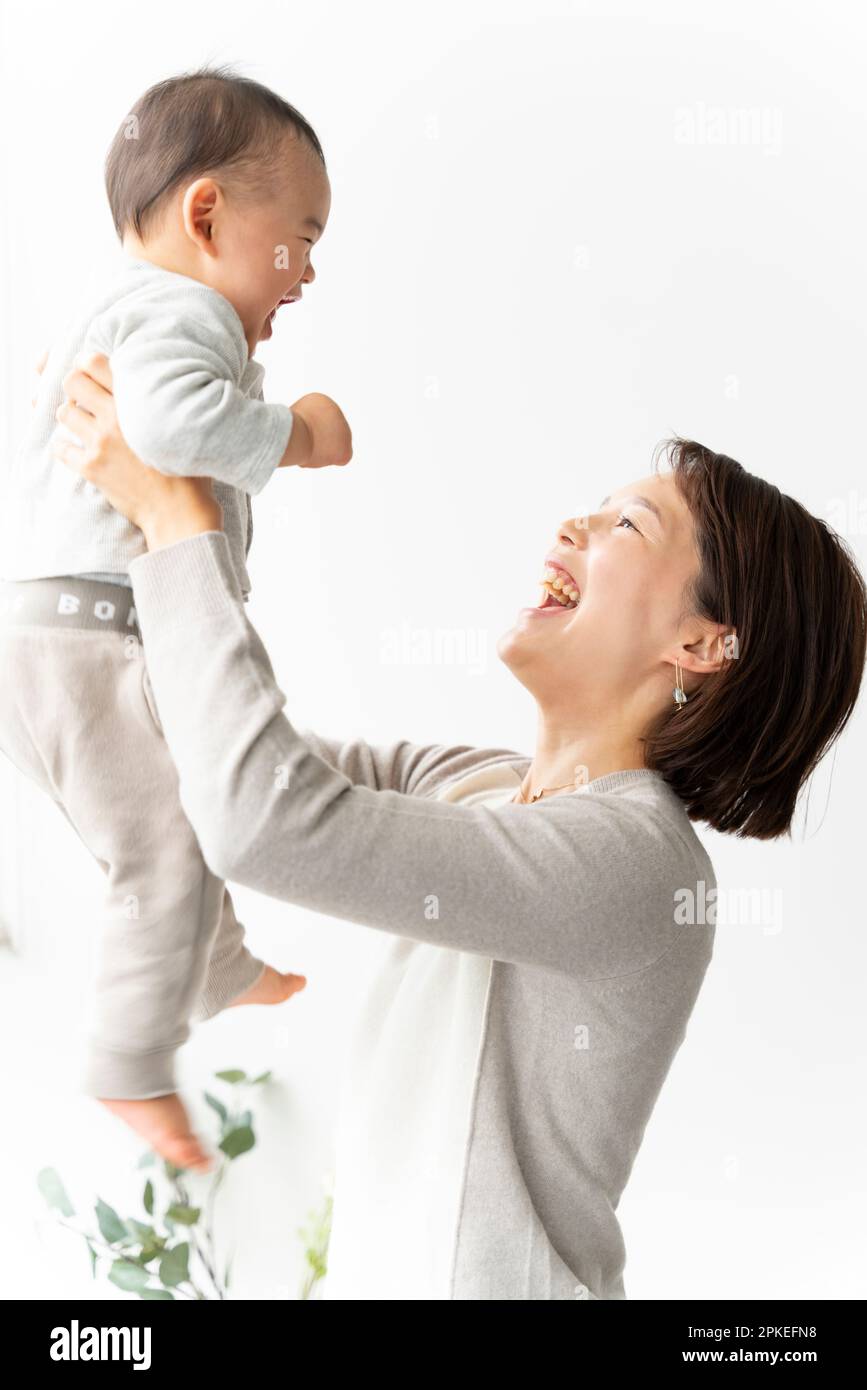 Smiling mother nursing baby hi-res stock photography and images - Alamy