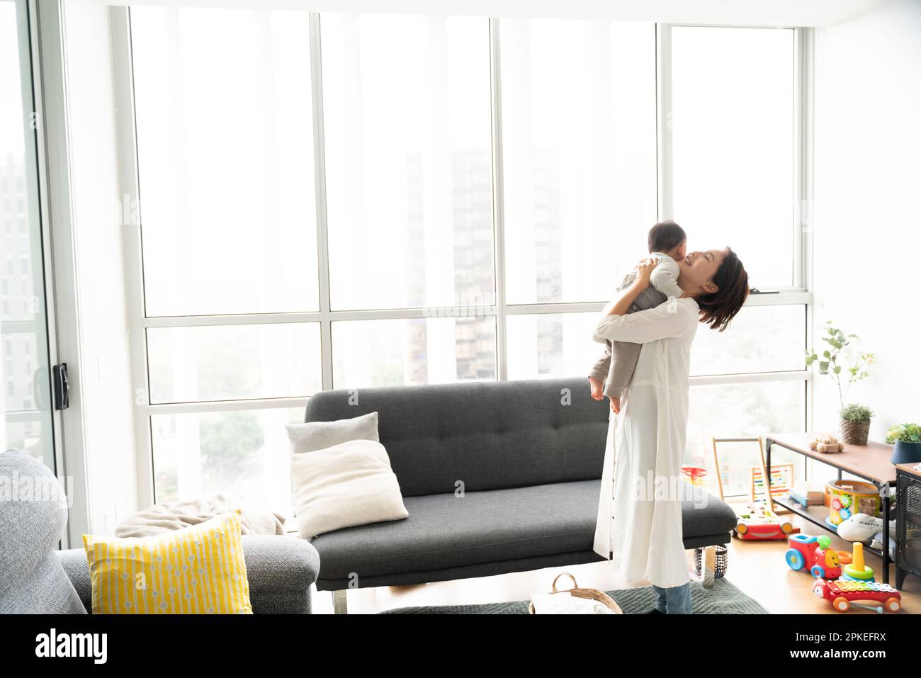 Mother carrying her baby indoors Stock Photo - Alamy Mother carrying her baby indoors Stock Photo - Alamy