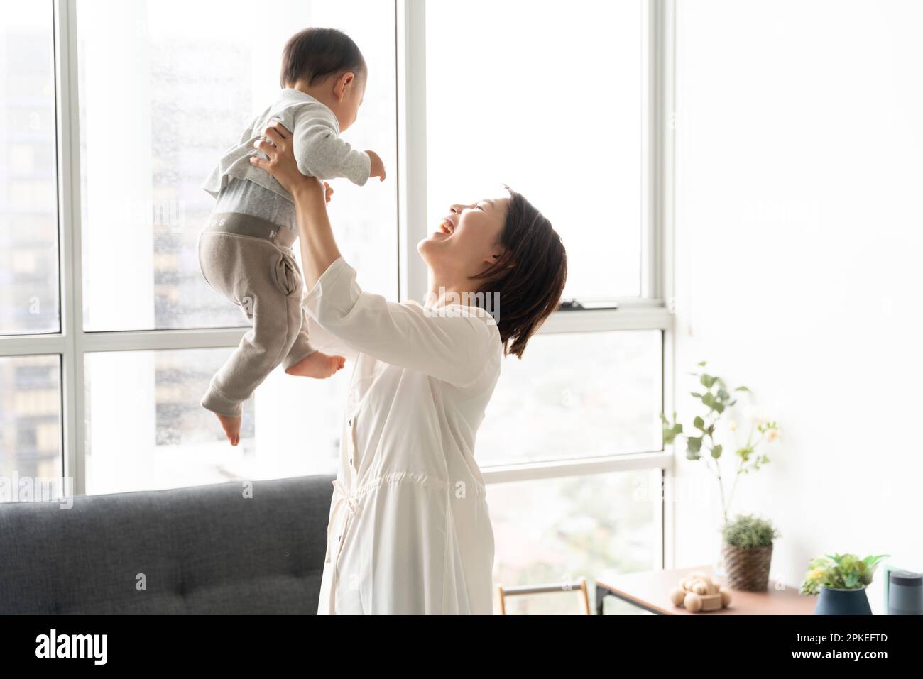 Asian parent nursing baby hi-res stock photography and images - Alamy