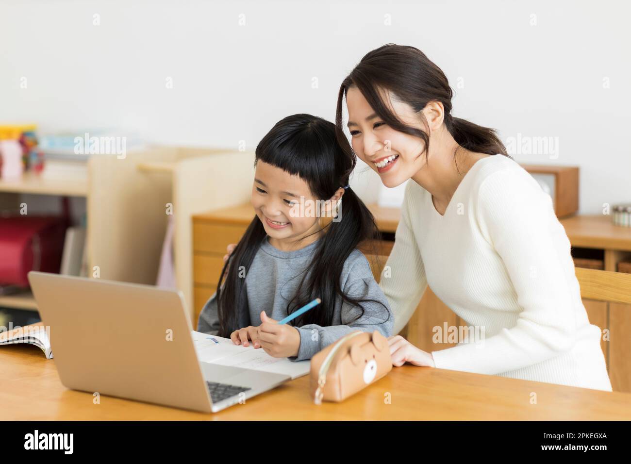 A girl and her mother learning online on the computer Stock Photo - Alamy