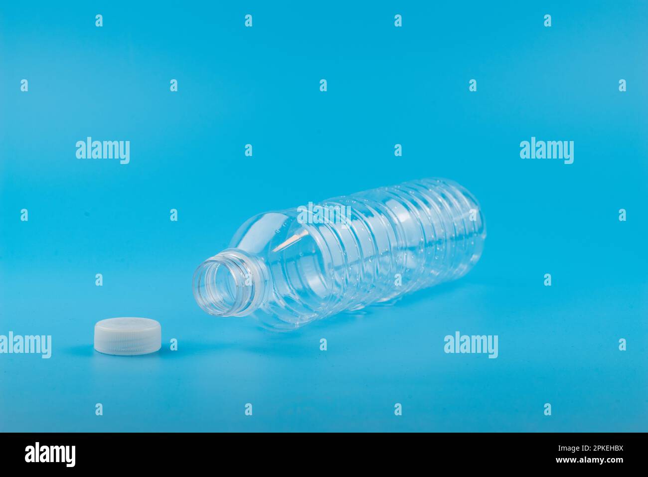 Empty crushed plastic bottle on blue background. Recyclable waste Stock ...