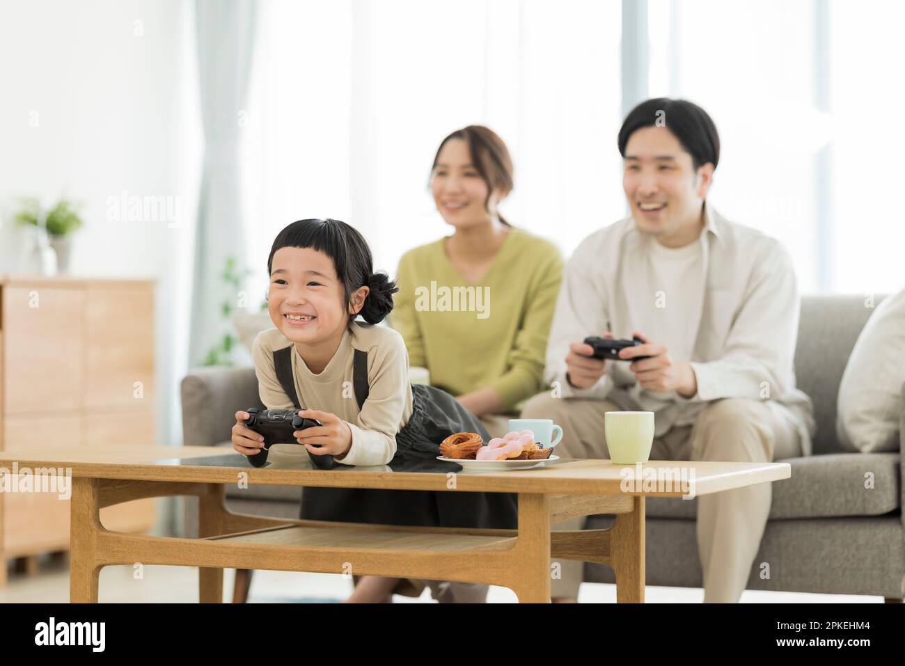 Family playing video games Stock Photo - Alamy