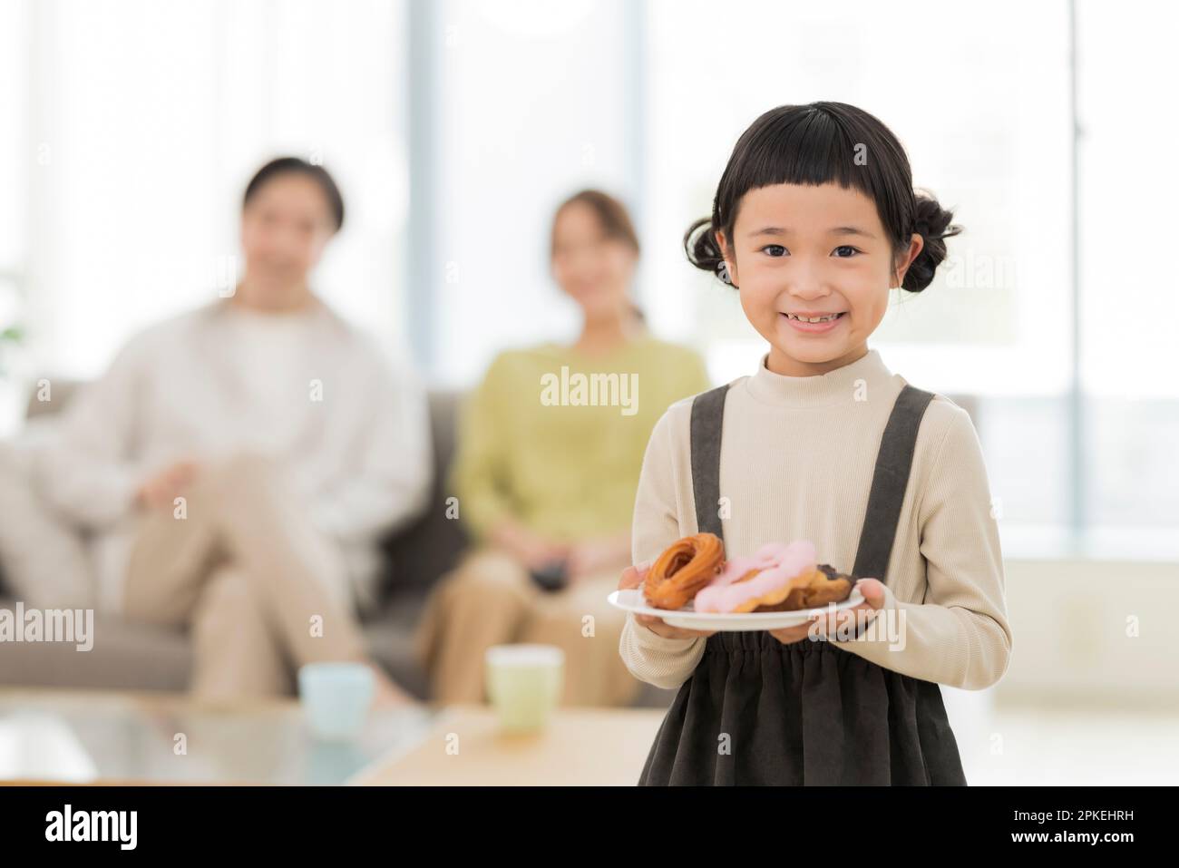 Girl smiling with donuts Stock Photo - Alamy