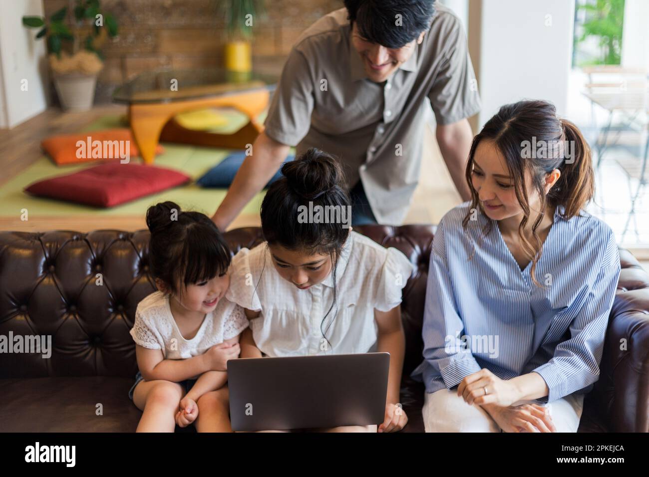 Family watching computer Stock Photo - Alamy