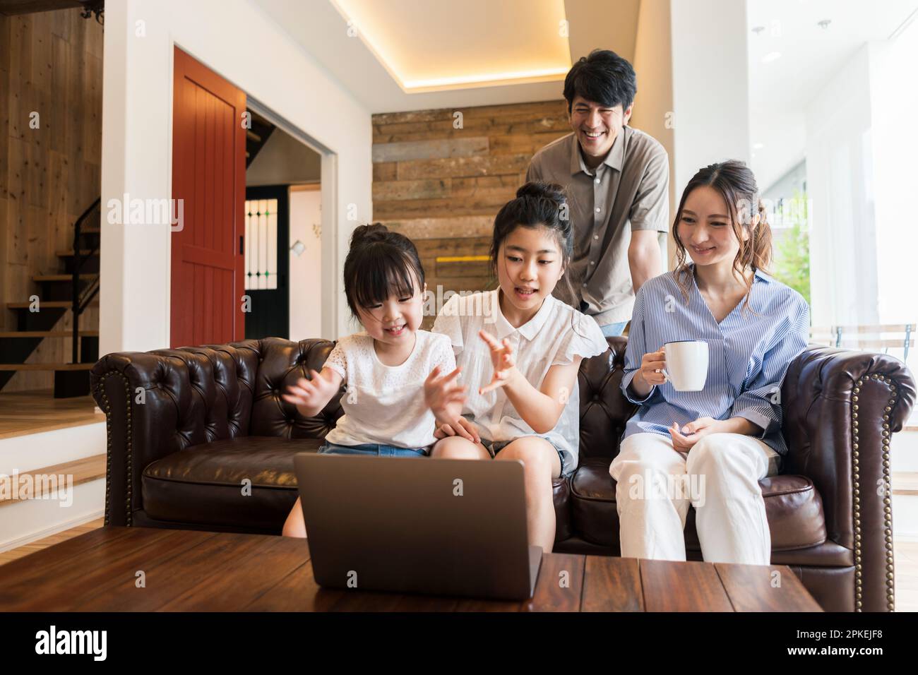 Family watching computer Stock Photo - Alamy