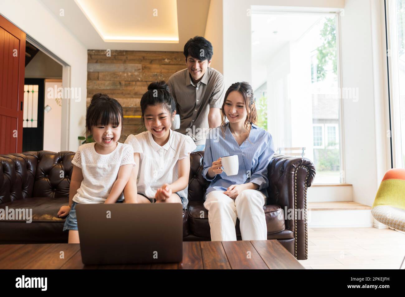 Family watching computer Stock Photo - Alamy