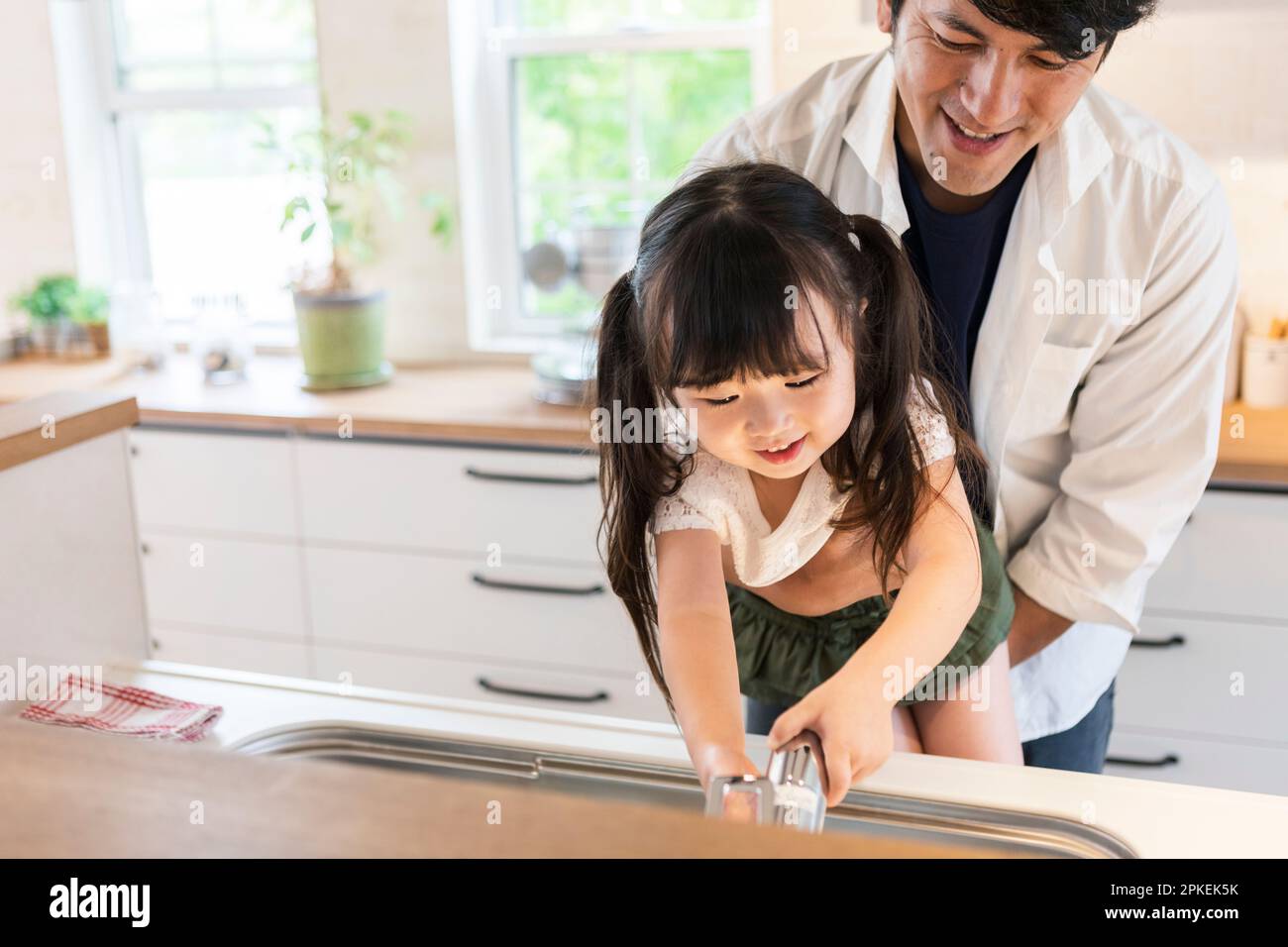 Parents and children washing hands Stock Photo - Alamy