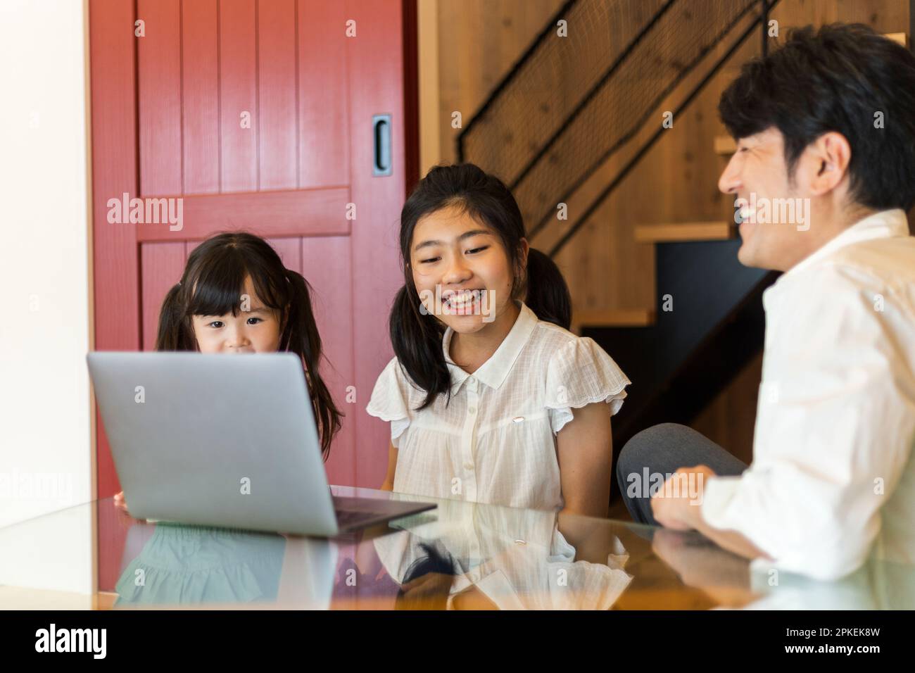 Family watching computer Stock Photo - Alamy