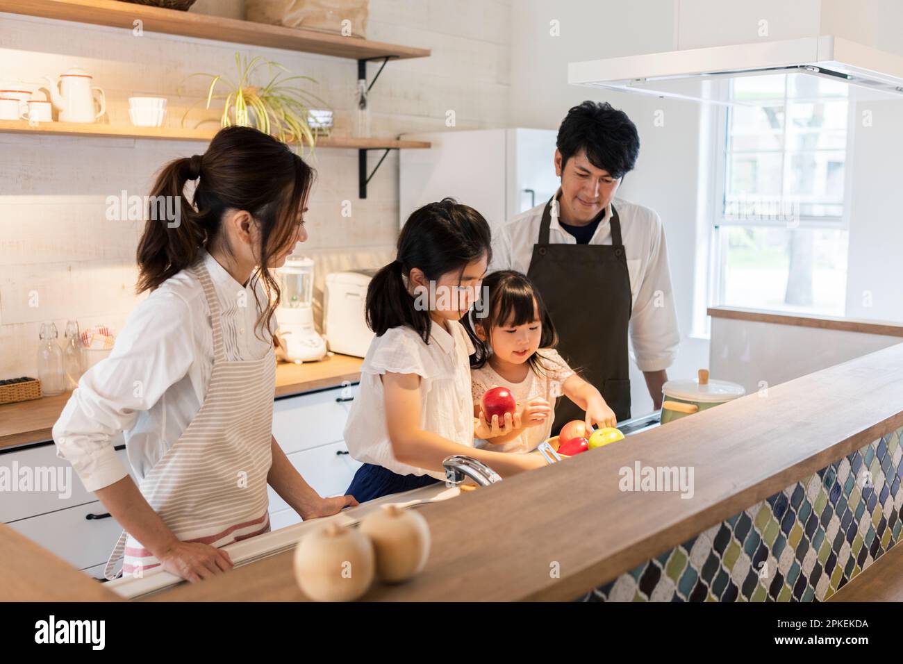 Family in the kitchen Stock Photo - Alamy