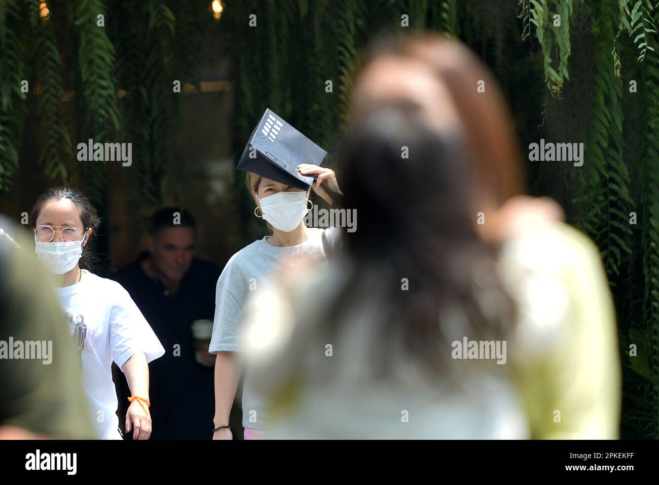 Bangkok. 7th Apr, 2023. A pedestrian shades herself from the sun in ...