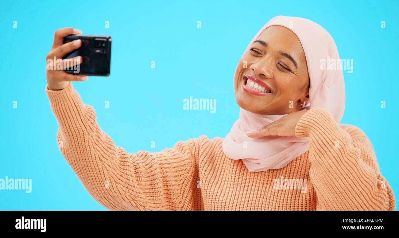 Selfie of muslim woman isolated on blue background for social media ...