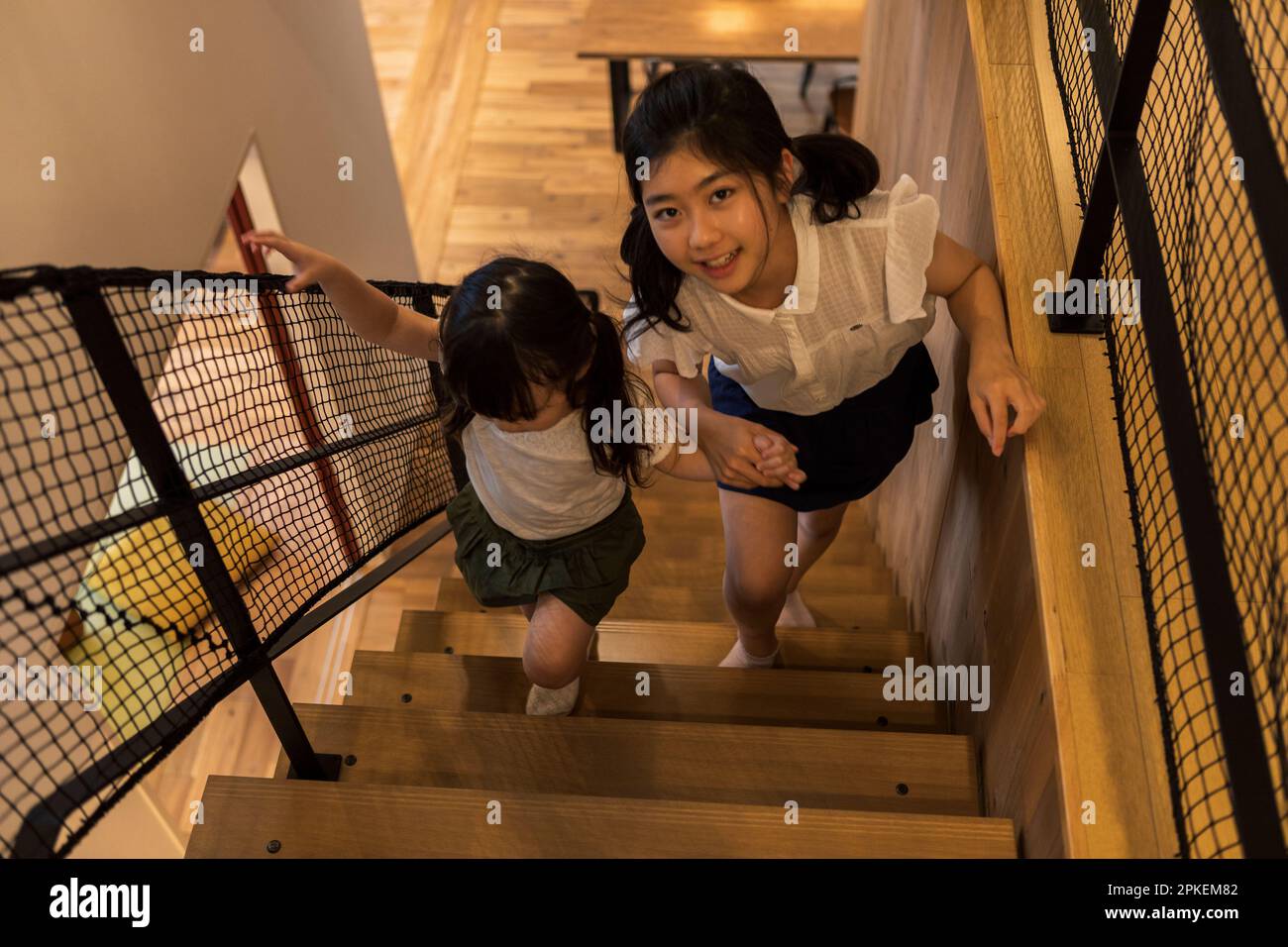 Sisters going up the stairs Stock Photo - Alamy