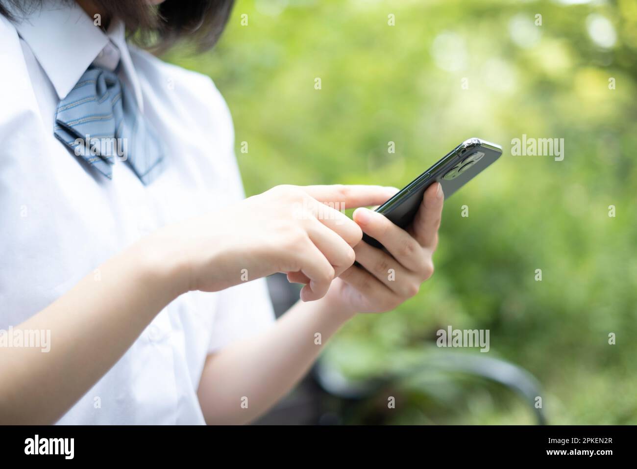 High school girl operating a cell phone Stock Photo - Alamy