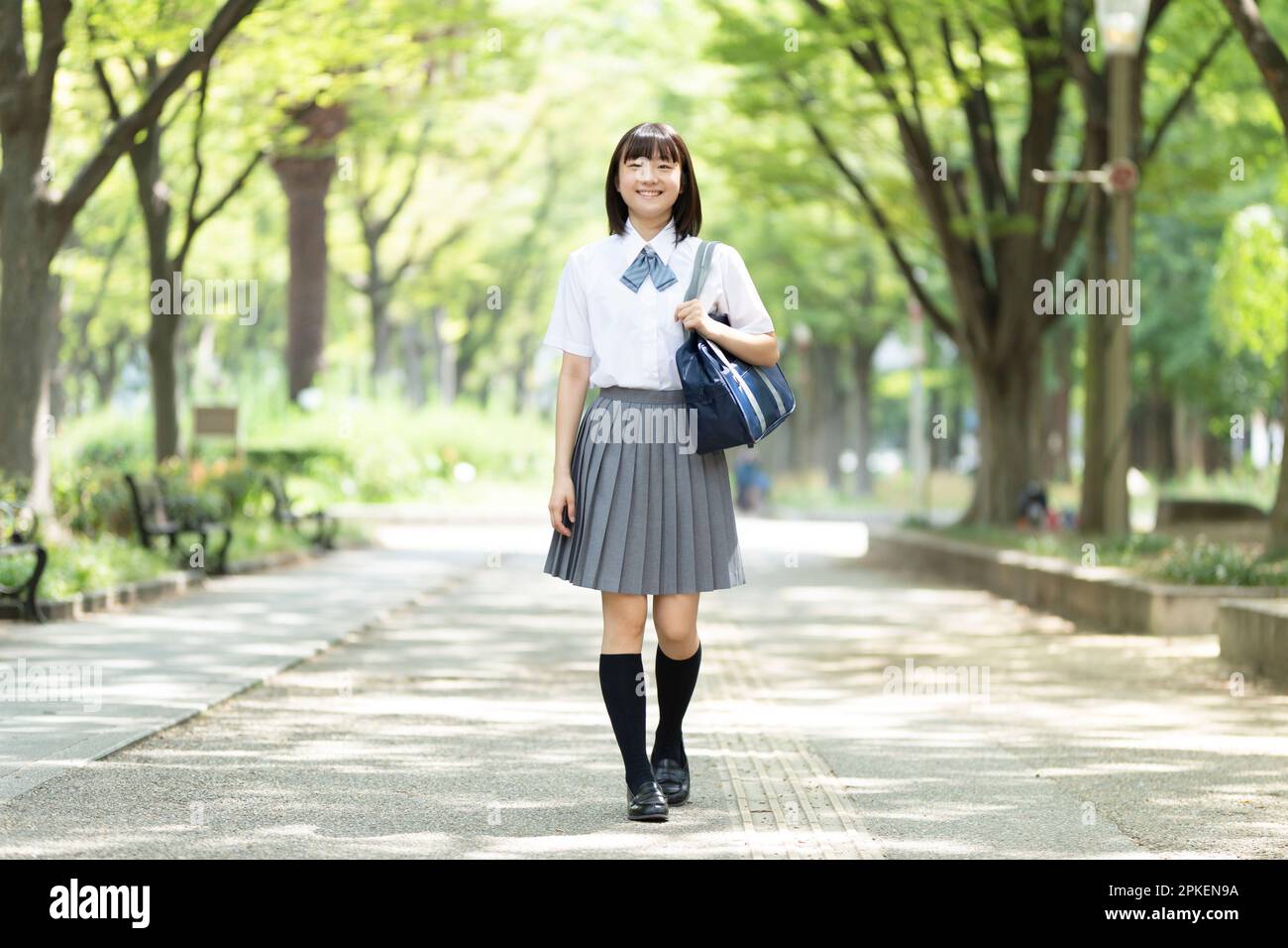 High school girl walking in the park Stock Photo - Alamy
