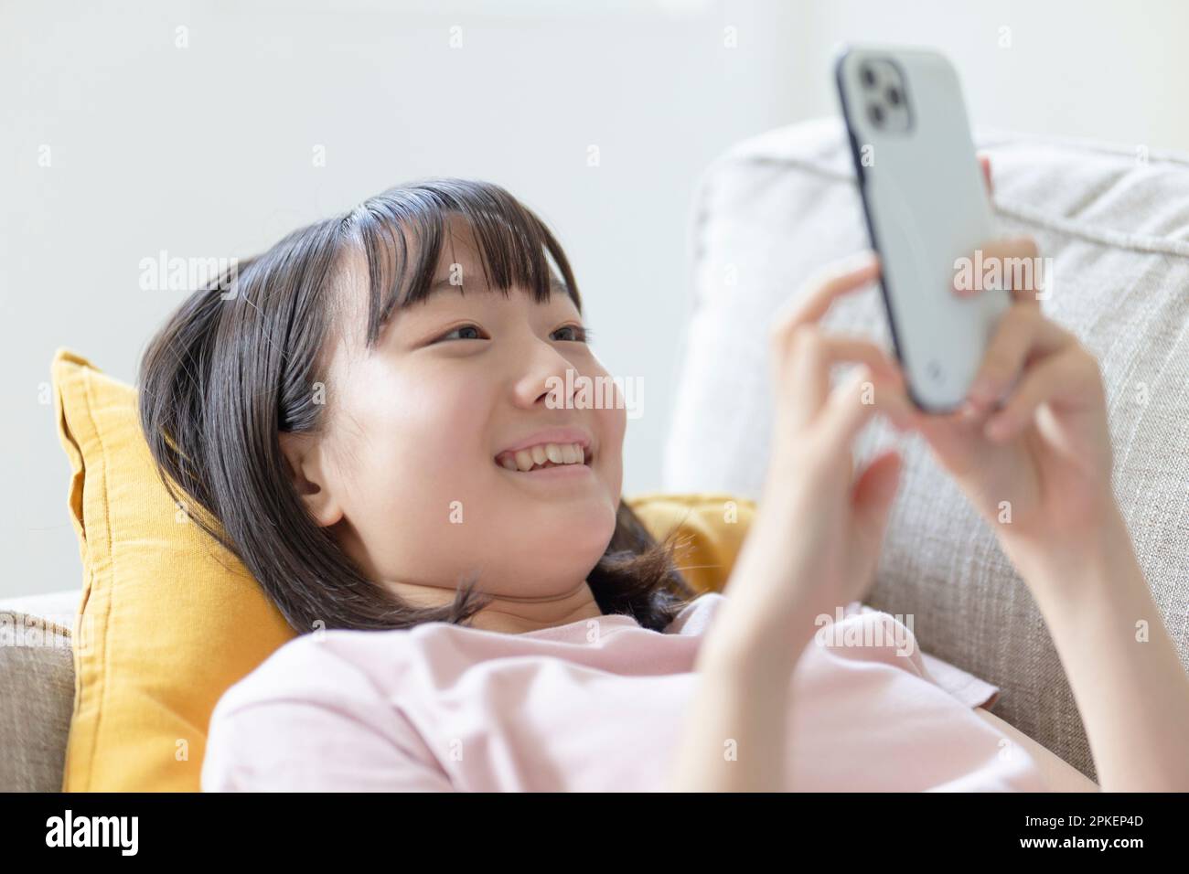 Asian girl on phone lying hi-res stock photography and images - Alamy