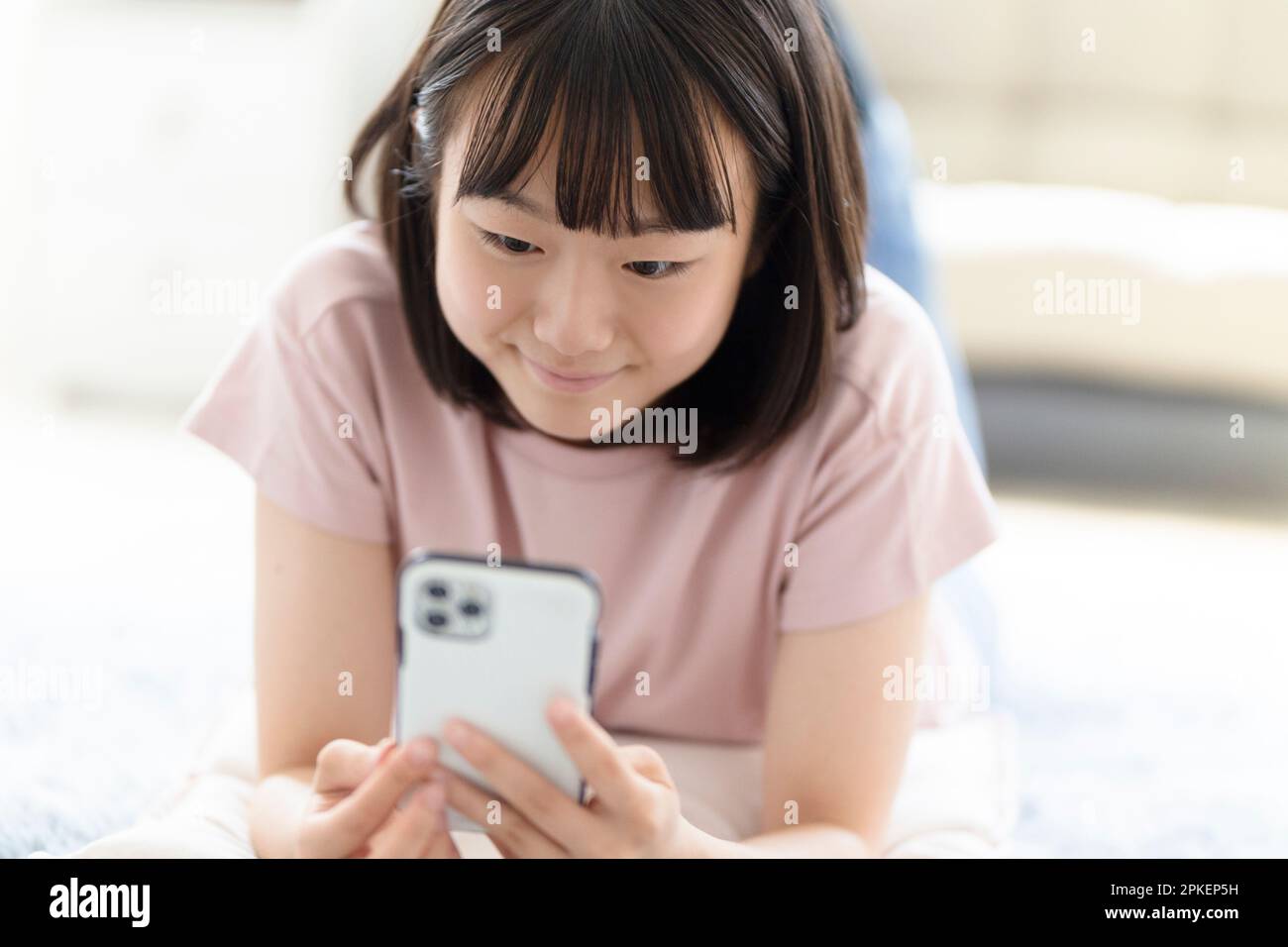 Girl looking at the phone Stock Photo - Alamy