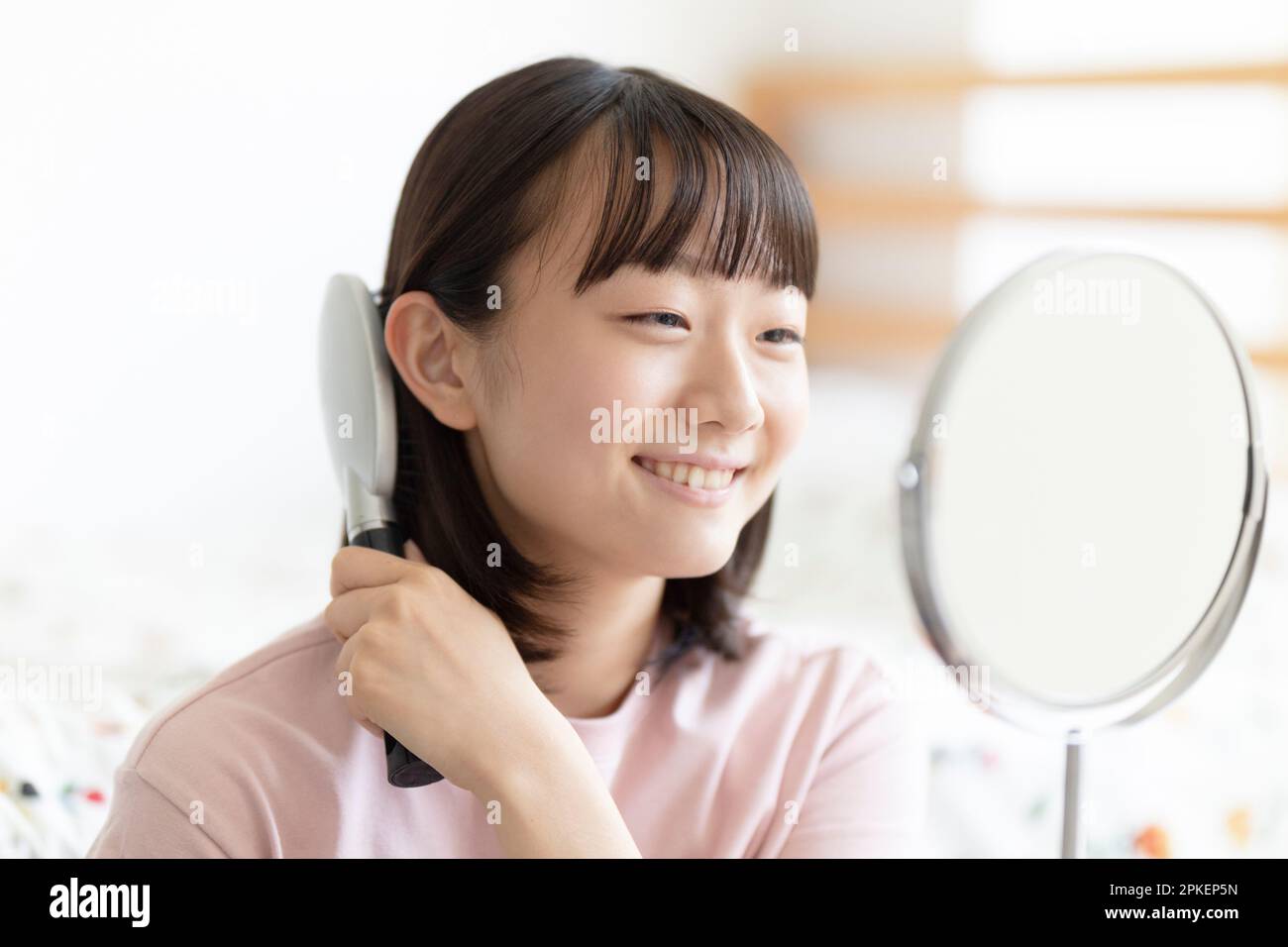 Girl looking in the mirror Stock Photo - Alamy