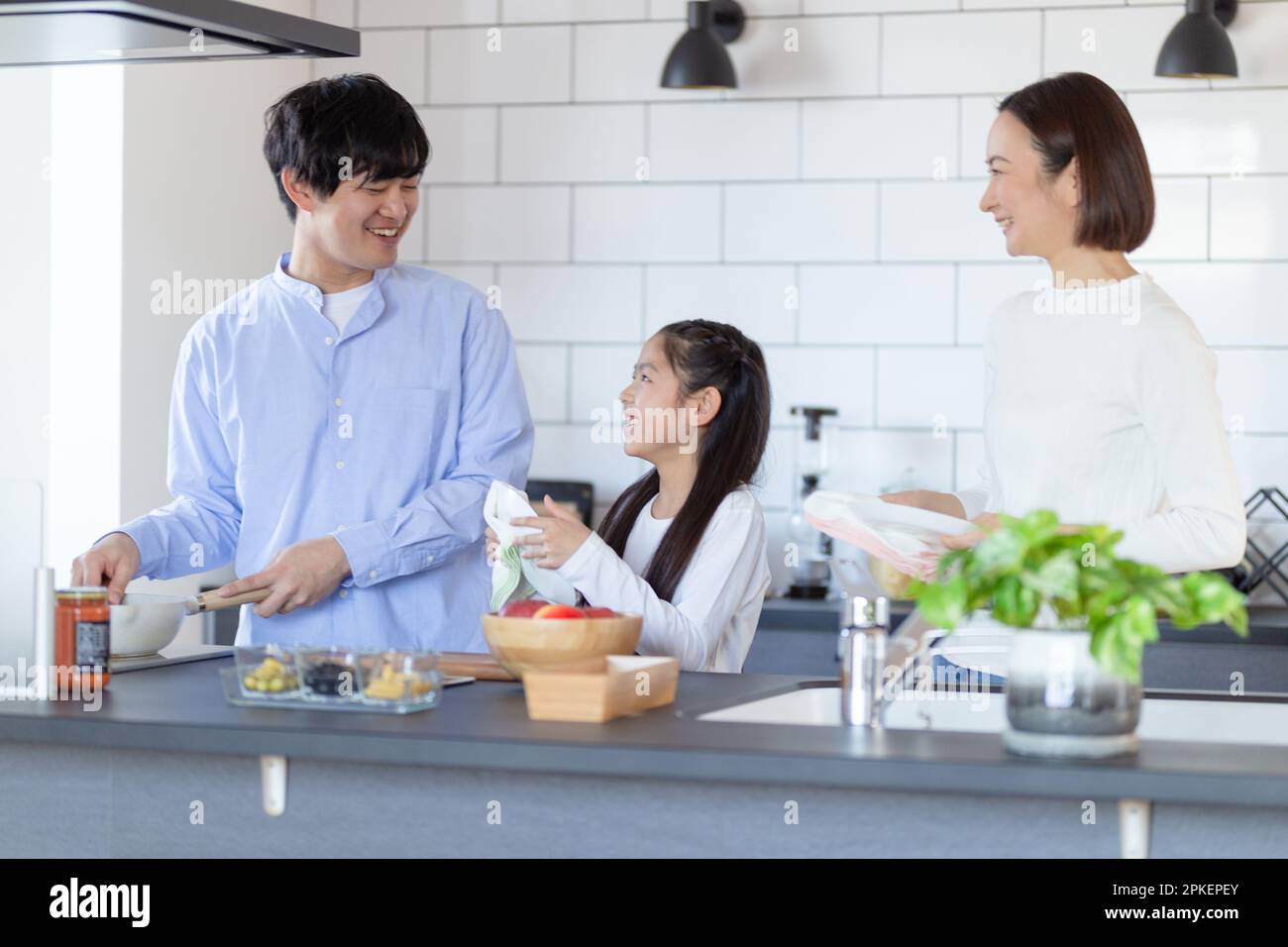 Girl standing in kitchen talking hi-res stock photography and images ...
