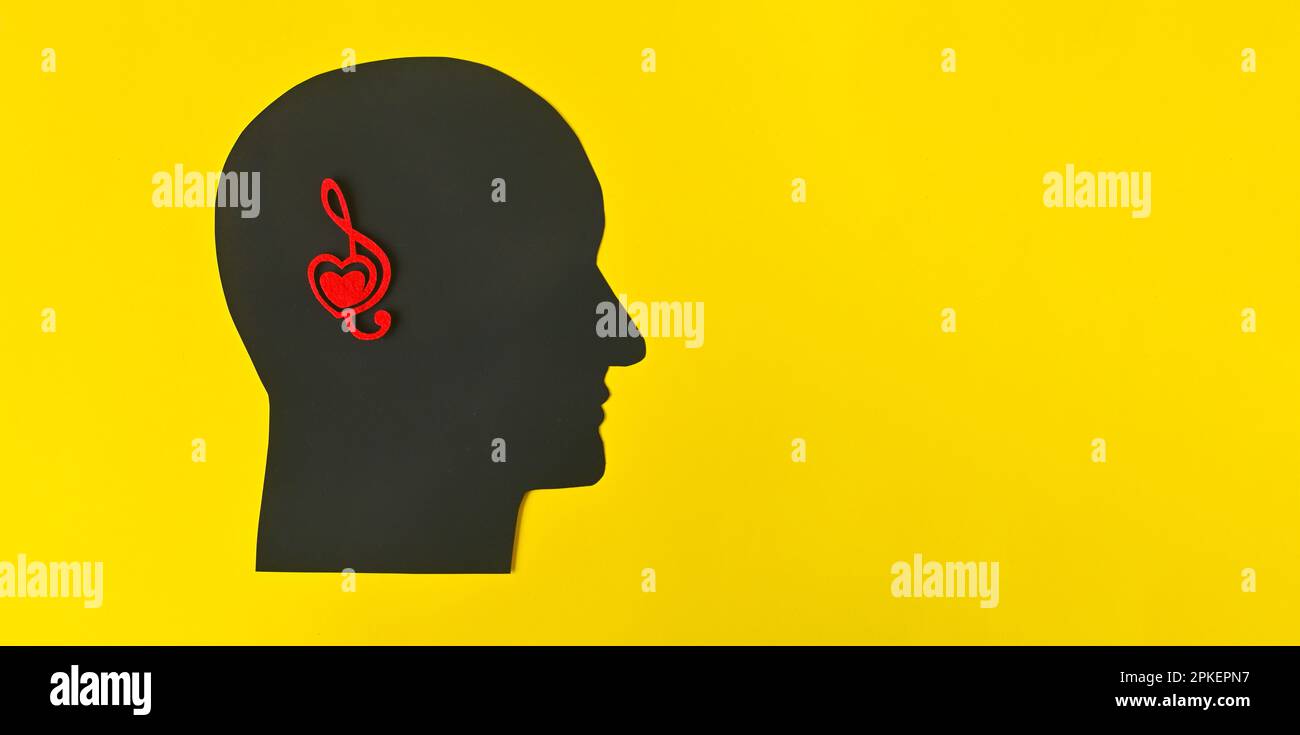 Silhouette of a man's head with a treble clef in his head. the concept ...
