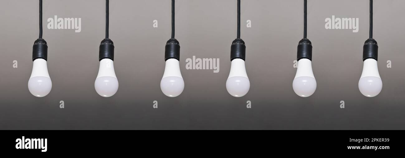 six LED lamps on wires in one row. banner Stock Photo - Alamy