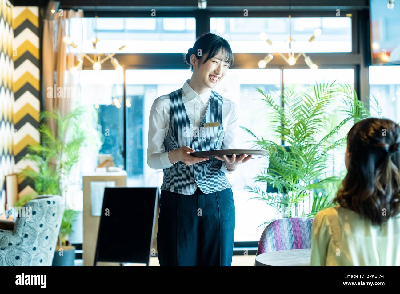 Cafe staff carrying coffee Stock Photo - Alamy
